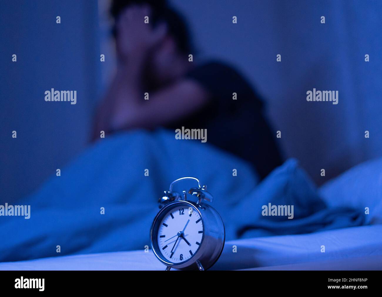 Young beautiful afro american woman at home lying in bed late at night ...