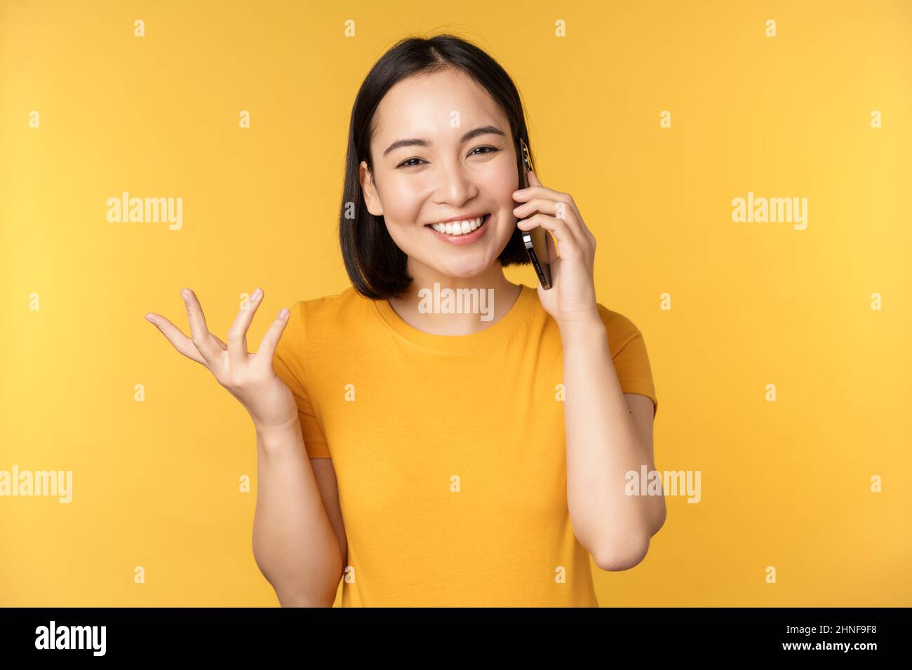 Young korean girl talking on mobile phone. Asian woman calling on ...