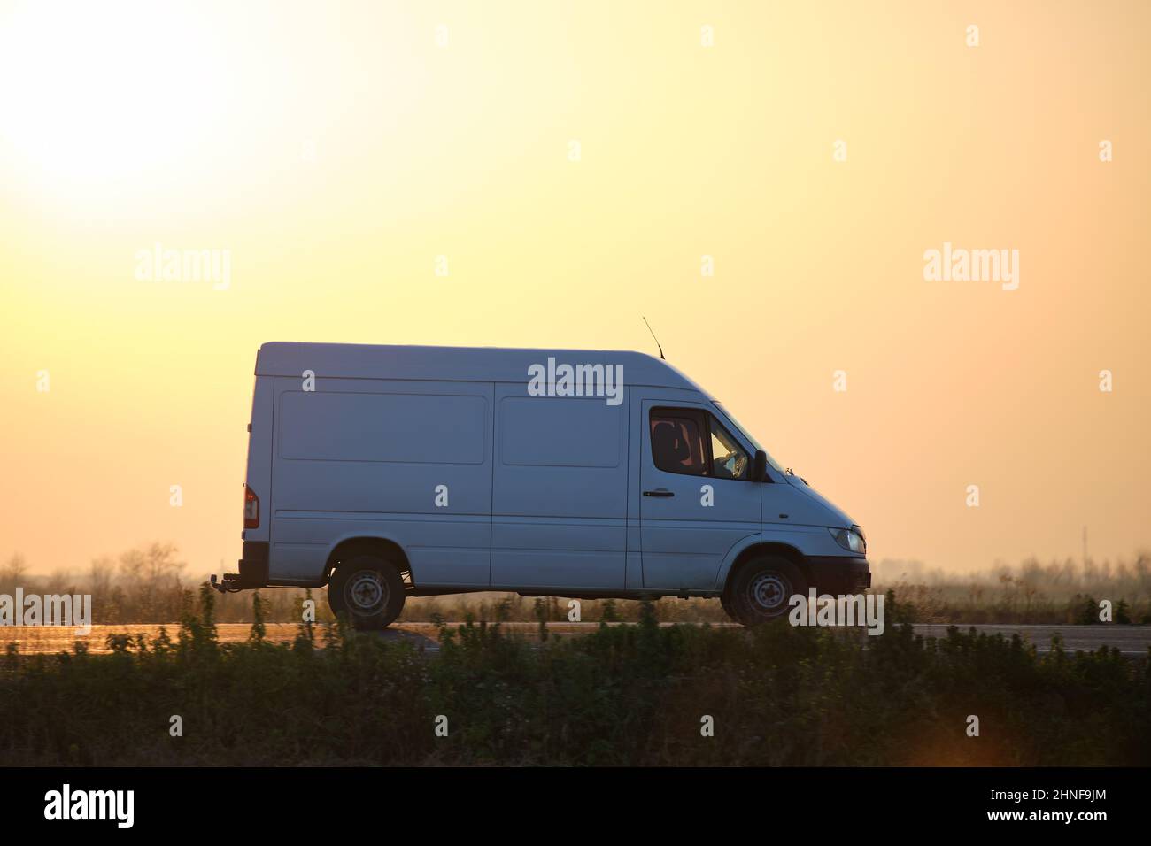 Small cargo van driving on highway hauling goods. Delivery ...