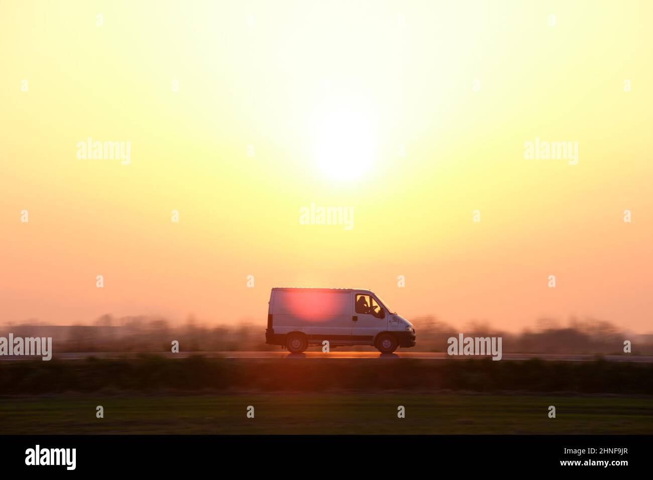 Small cargo van driving on highway hauling goods. Delivery ...