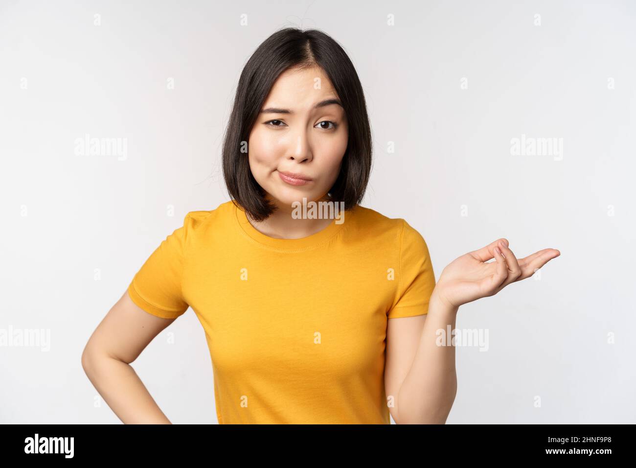 So what. Unbothered asian woman shrugging, looking clueless, standing ...