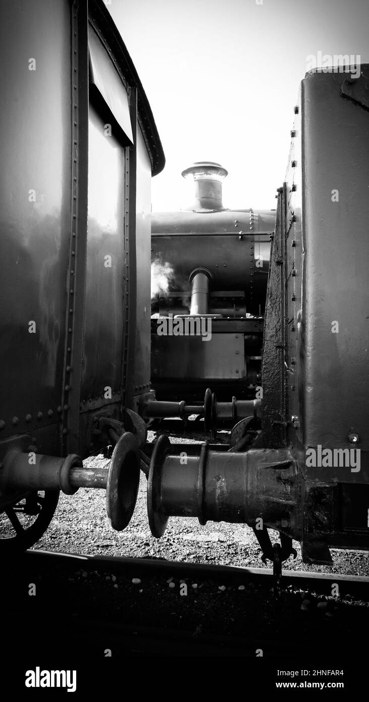 Black and white of steam pass the two wagons Stock Photo - Alamy