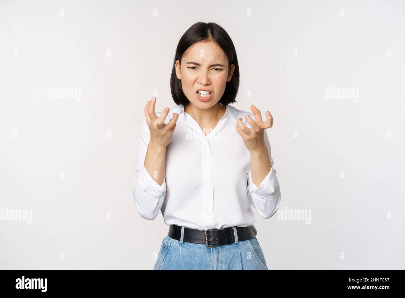 Image of angry pissed off woman shaking from anger, clench hands and grimacing furious, annoyed ...