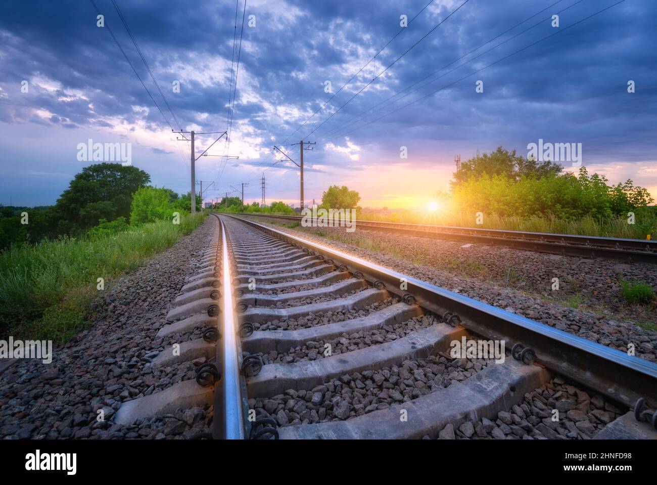 Railroad and beautiful sky at sunset in summer. Railway station Stock ...
