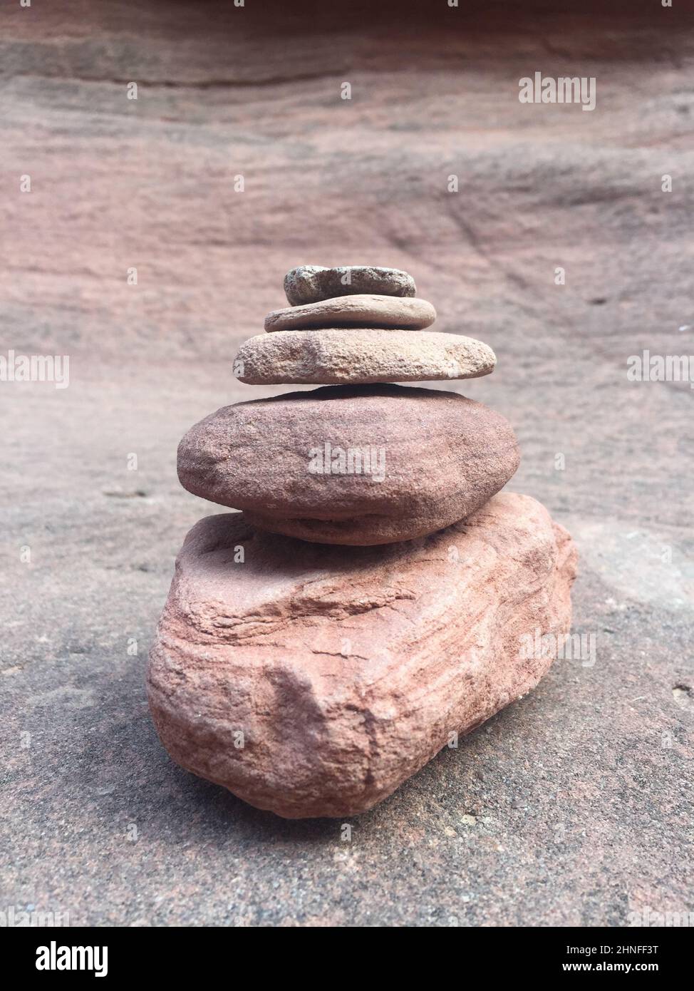 five stones stacked from largest to smallest Stock Photo - Alamy