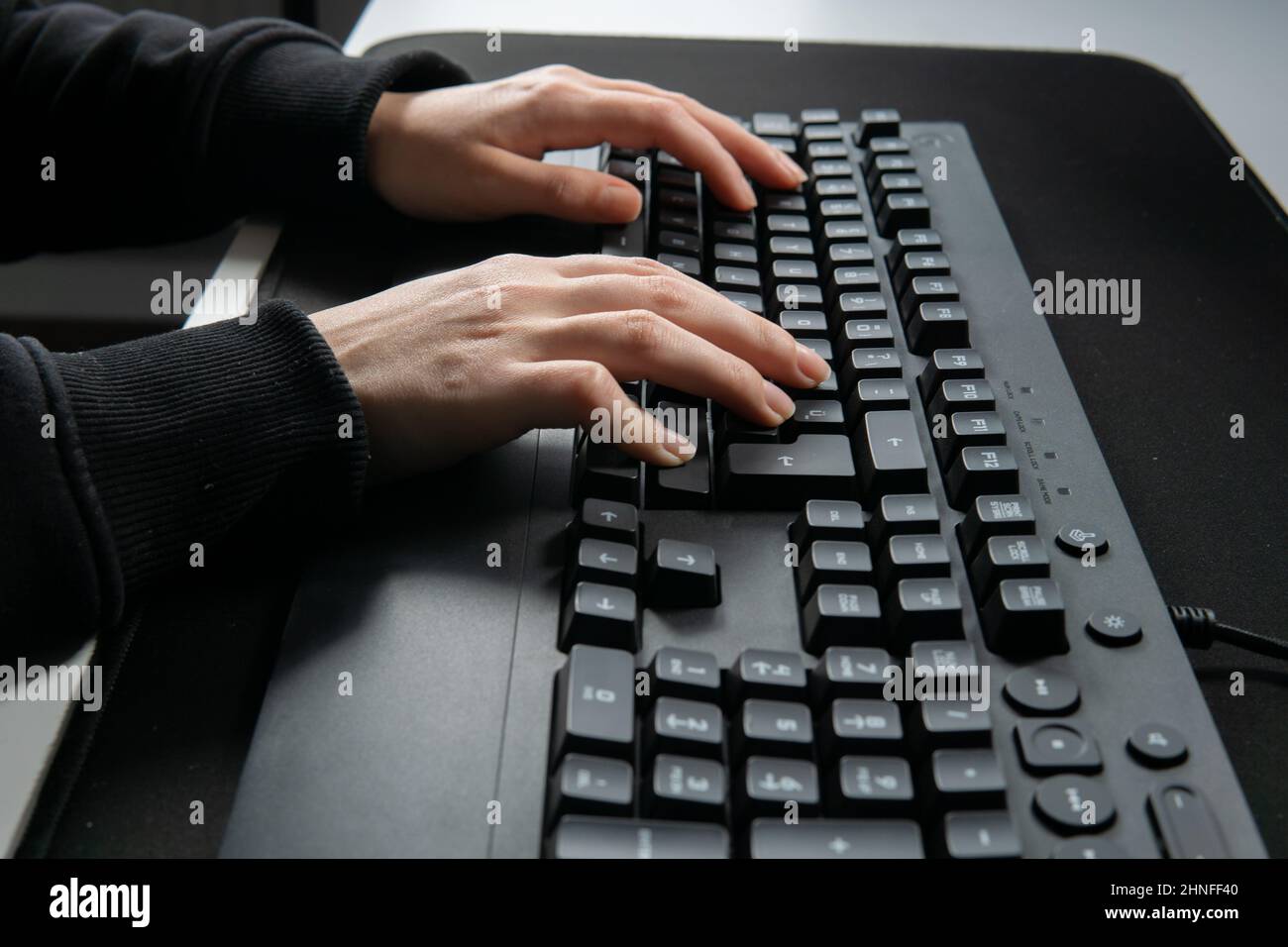 Close up image of woman hands typing on computer keyboard and surfing ...