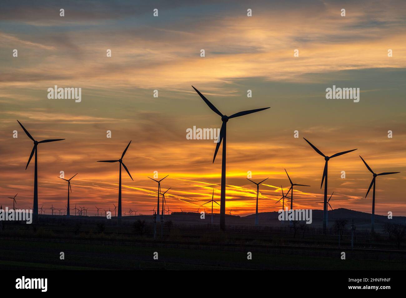 Group of wind power turbines at a sunset Stock Photo - Alamy
