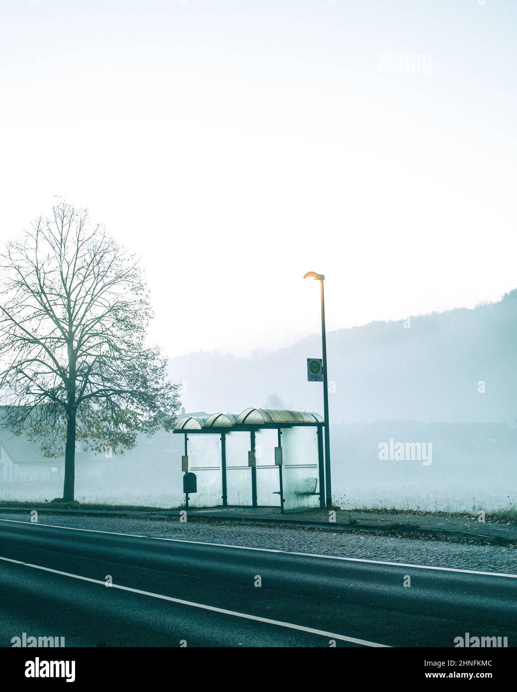 Vertical shot of a bus stop next to the highway Stock Photo - Alamy