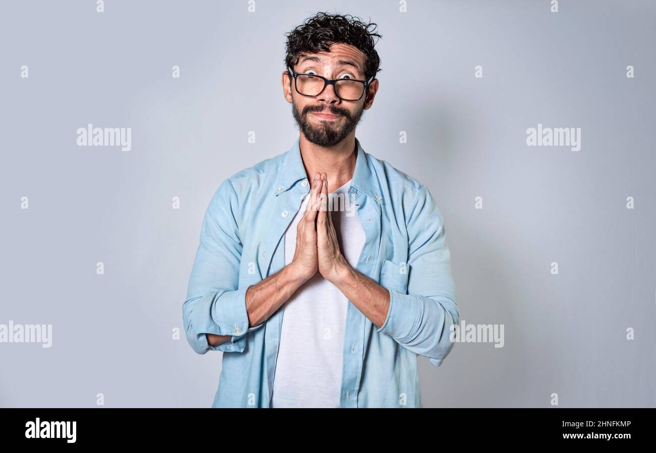 Man asking please, guy putting hands together asking please, worried ...