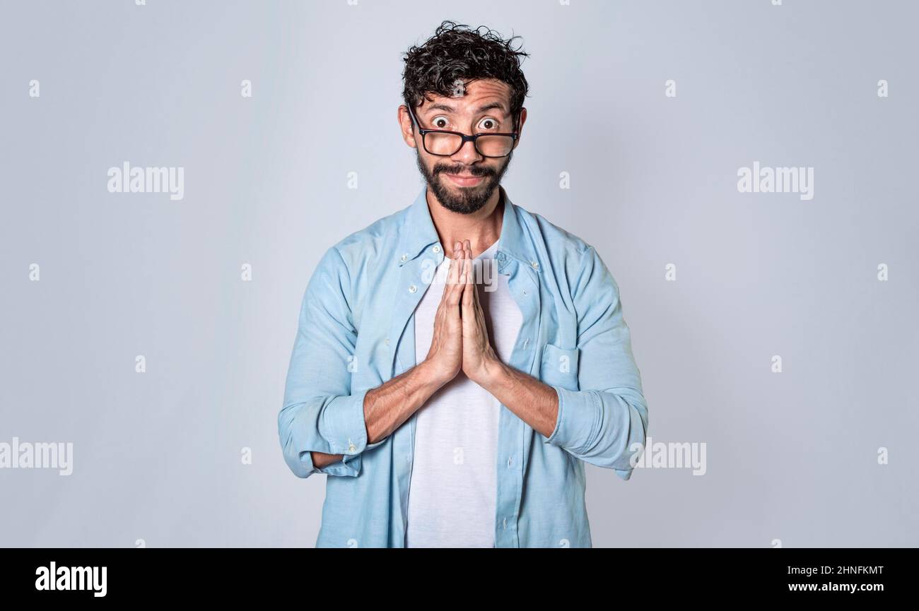 Man asking please, guy putting hands together asking please, worried ...