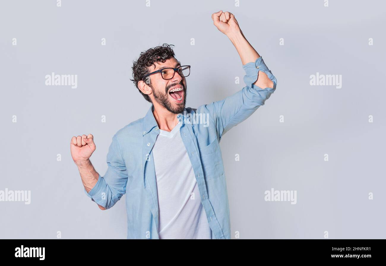 Guy raising hands in victory sign, latin man raising hands in victory ...