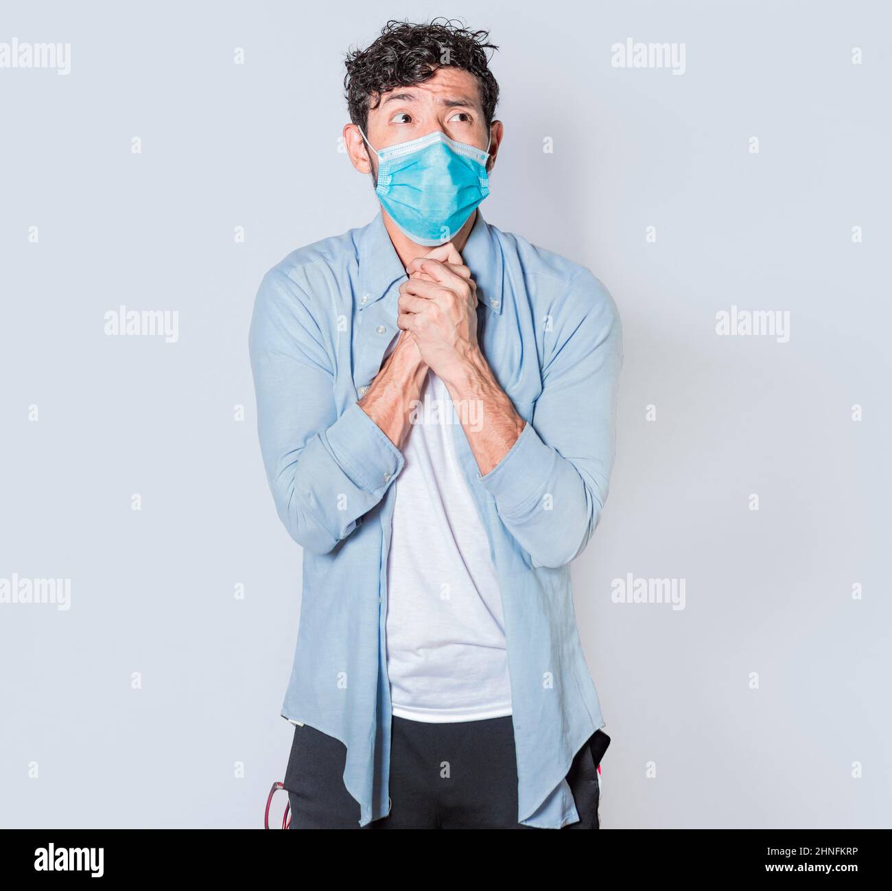 Latin man begging with medical protective face mask. pleading man ...