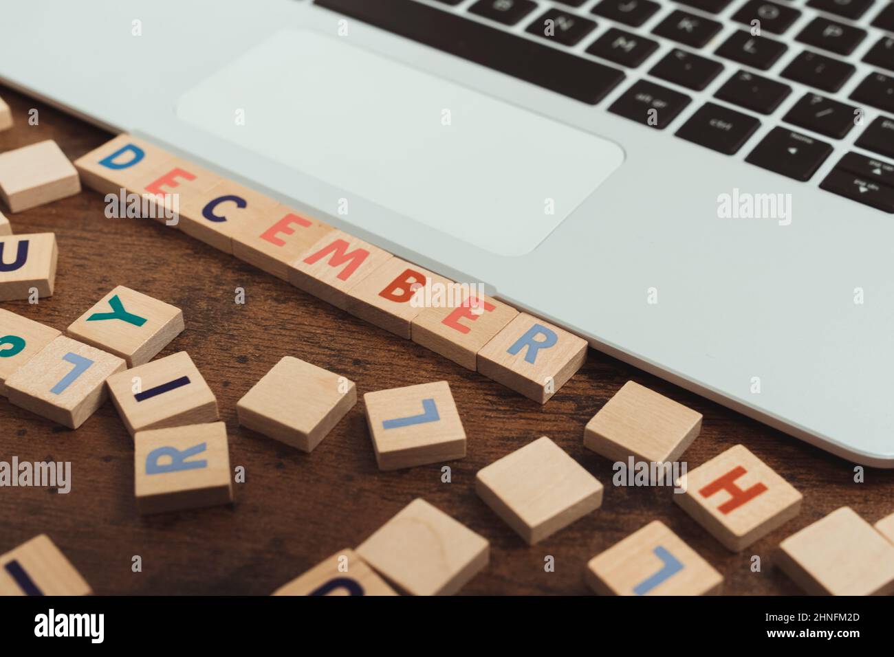 The name of the month December written on wooden cubes od the tabletop ...