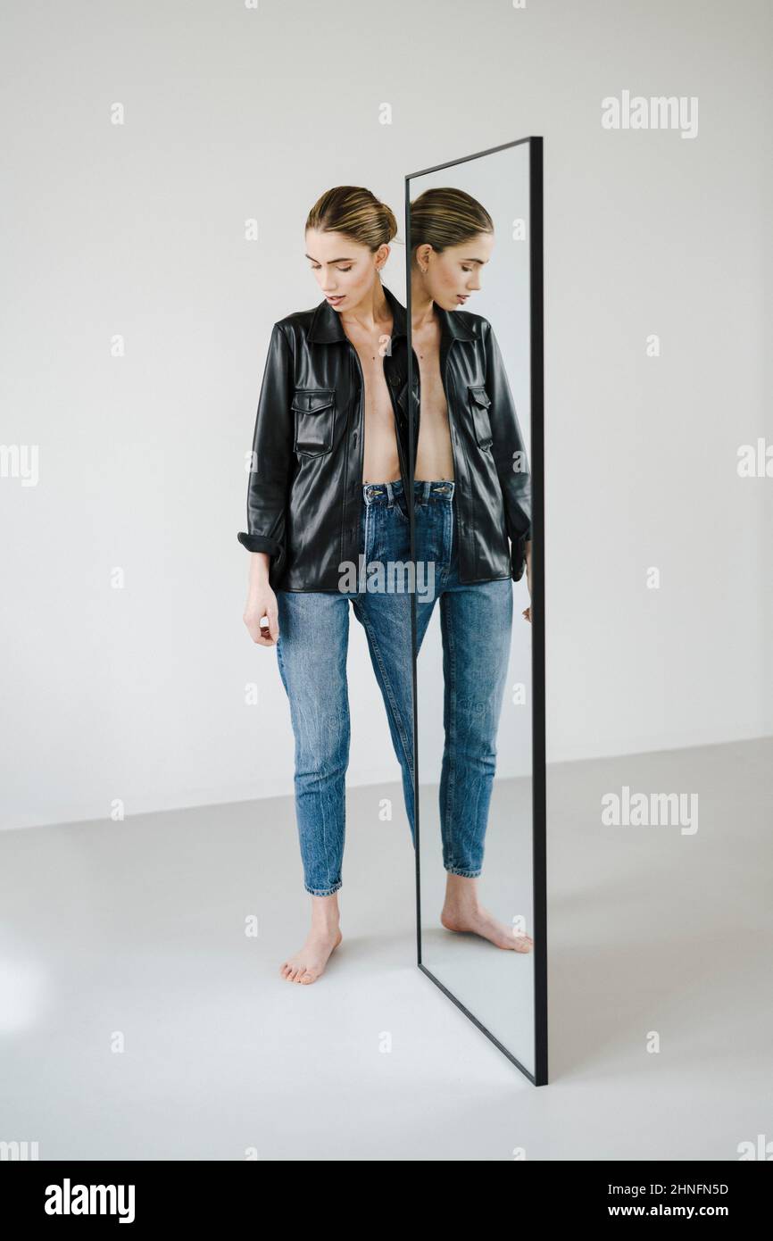 Attractive Young Woman Reflected in Body-Size Mirror Stock Photo - Alamy