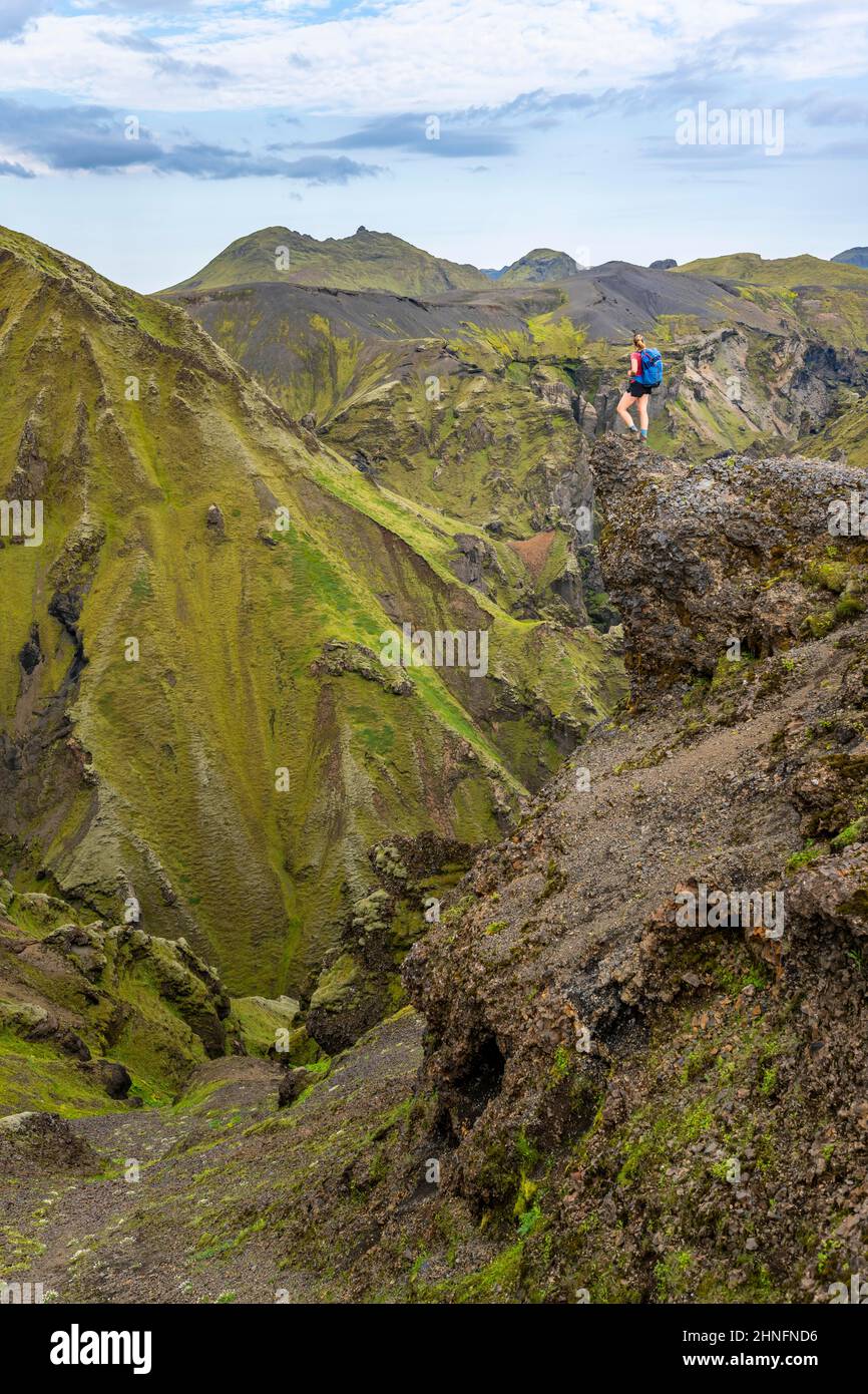 Hiker looks over spectacular landscape, moss-covered cliffs, Pakgil ...