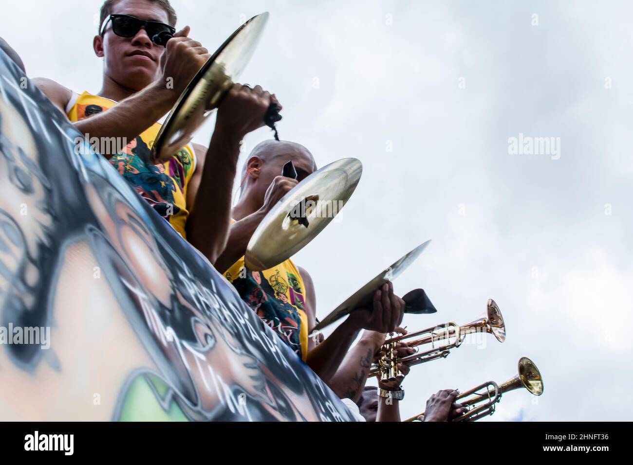 Musicians playing wind instruments against a blue sky. City of ...