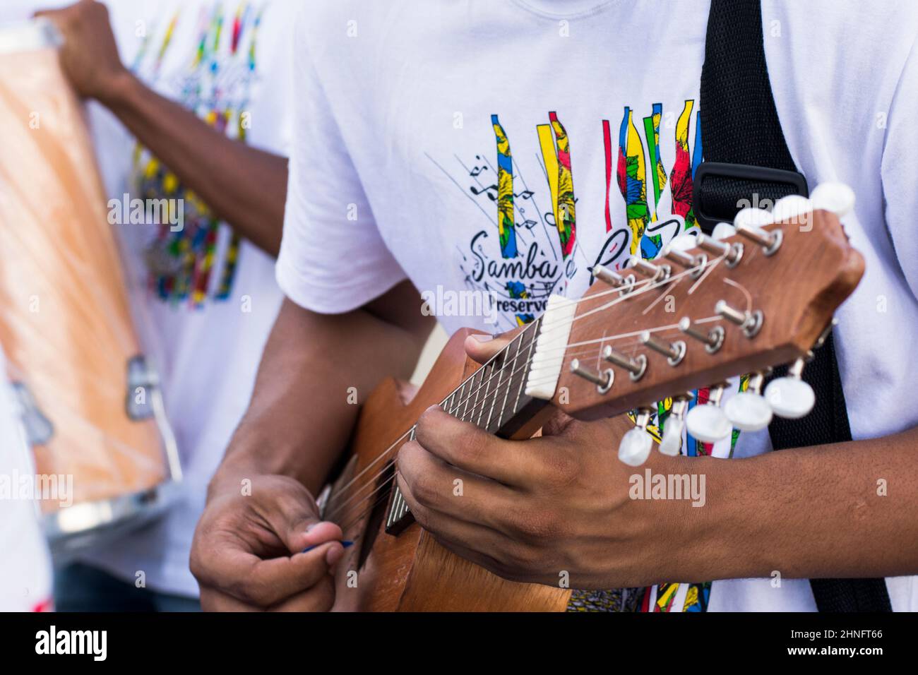 A people playing ukulele at a cultural event in the city of Saubara ...