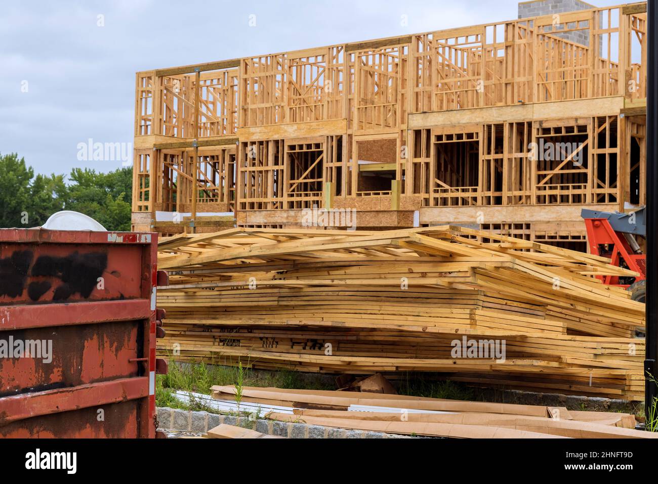 Stack at the lumber wood planks for beams in the construction of a new ...