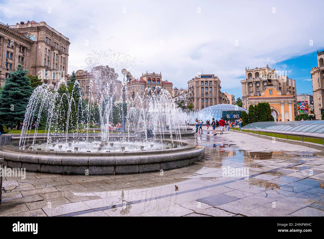 Water fountain at independence square with city buildings Stock Photo ...