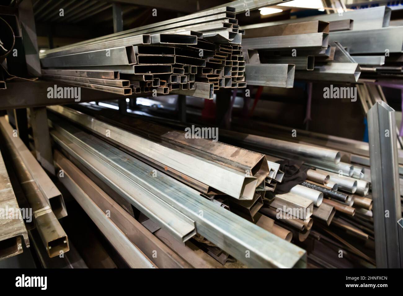 Steel shaped tubes on shelving rack Stock Photo - Alamy