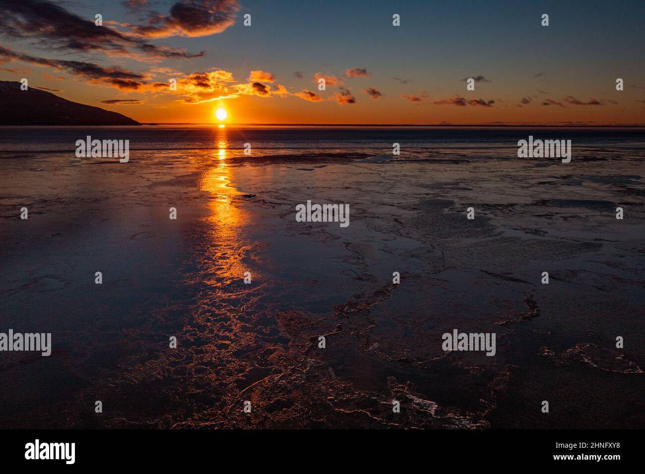 Sunset glows across Cook Inlet and the headwaters of Turnagain Arm near ...