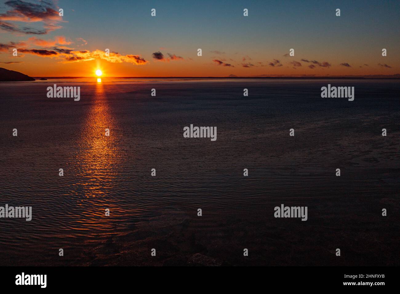 Sunset glows across Cook Inlet and the headwaters of Turnagain Arm near ...