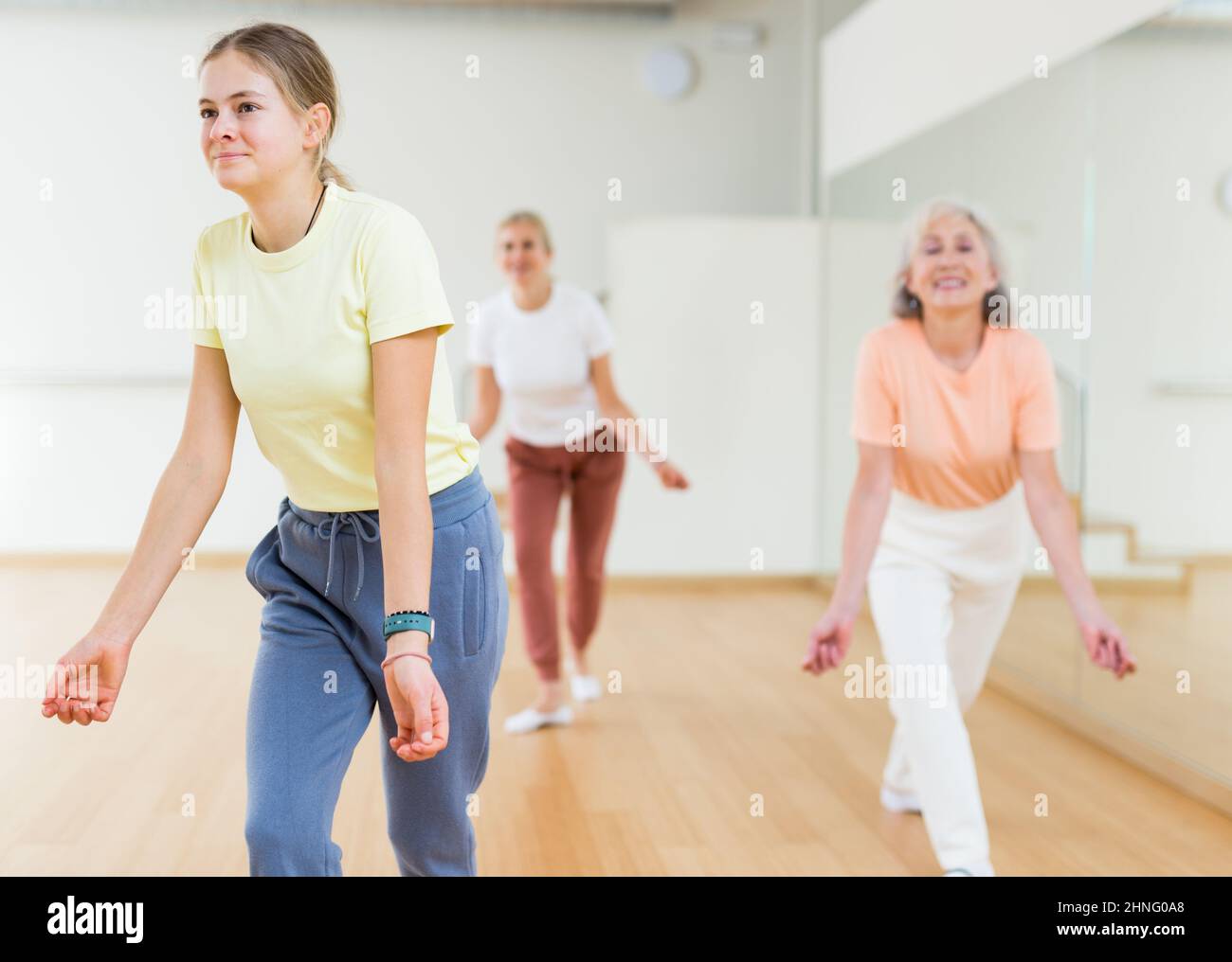 Girl performing jazz dance during group training in studio Stock Photo ...