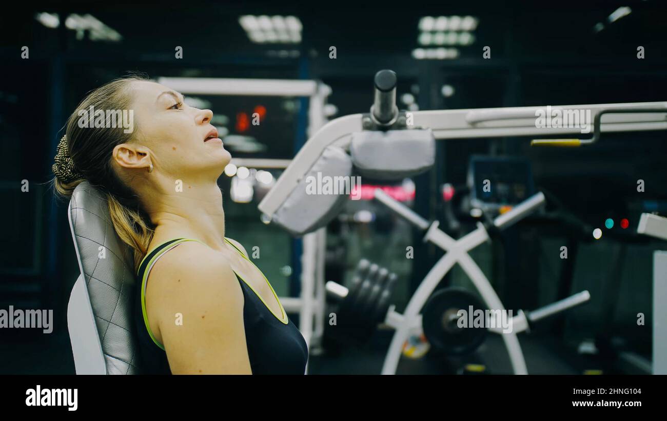Sleeping woman in gym with her head on a trainer. Rest relax after ...