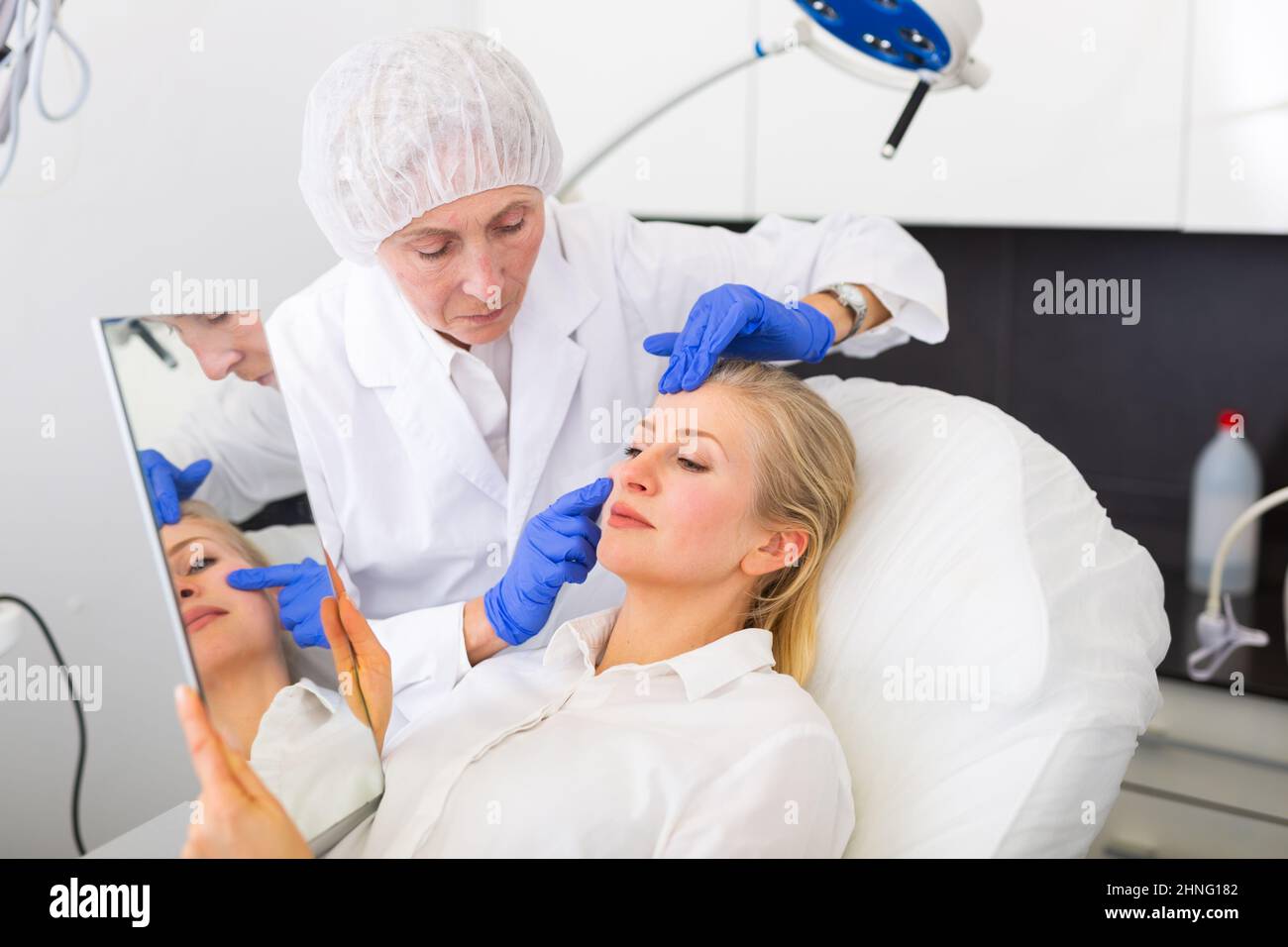 Cosmetologist and young woman after face lifting procedures Stock Photo ...