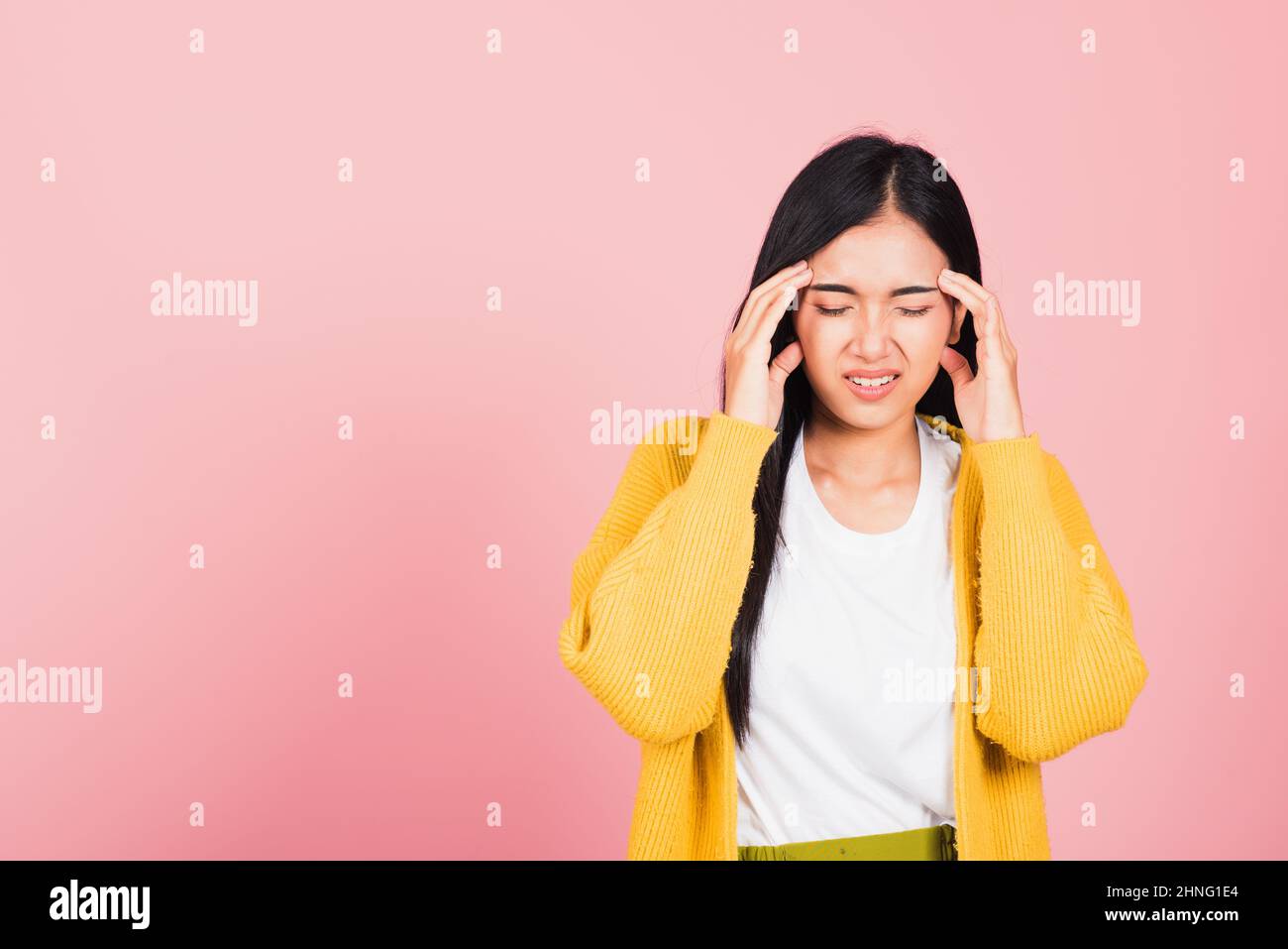 Portrait of beautiful Asian young woman sad tired strain face holding ...