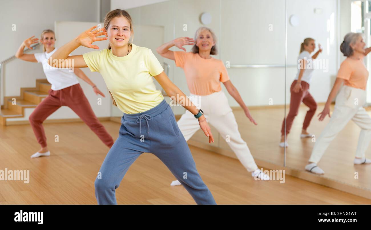 Young girl performing aerobic dance during group training Stock Photo ...