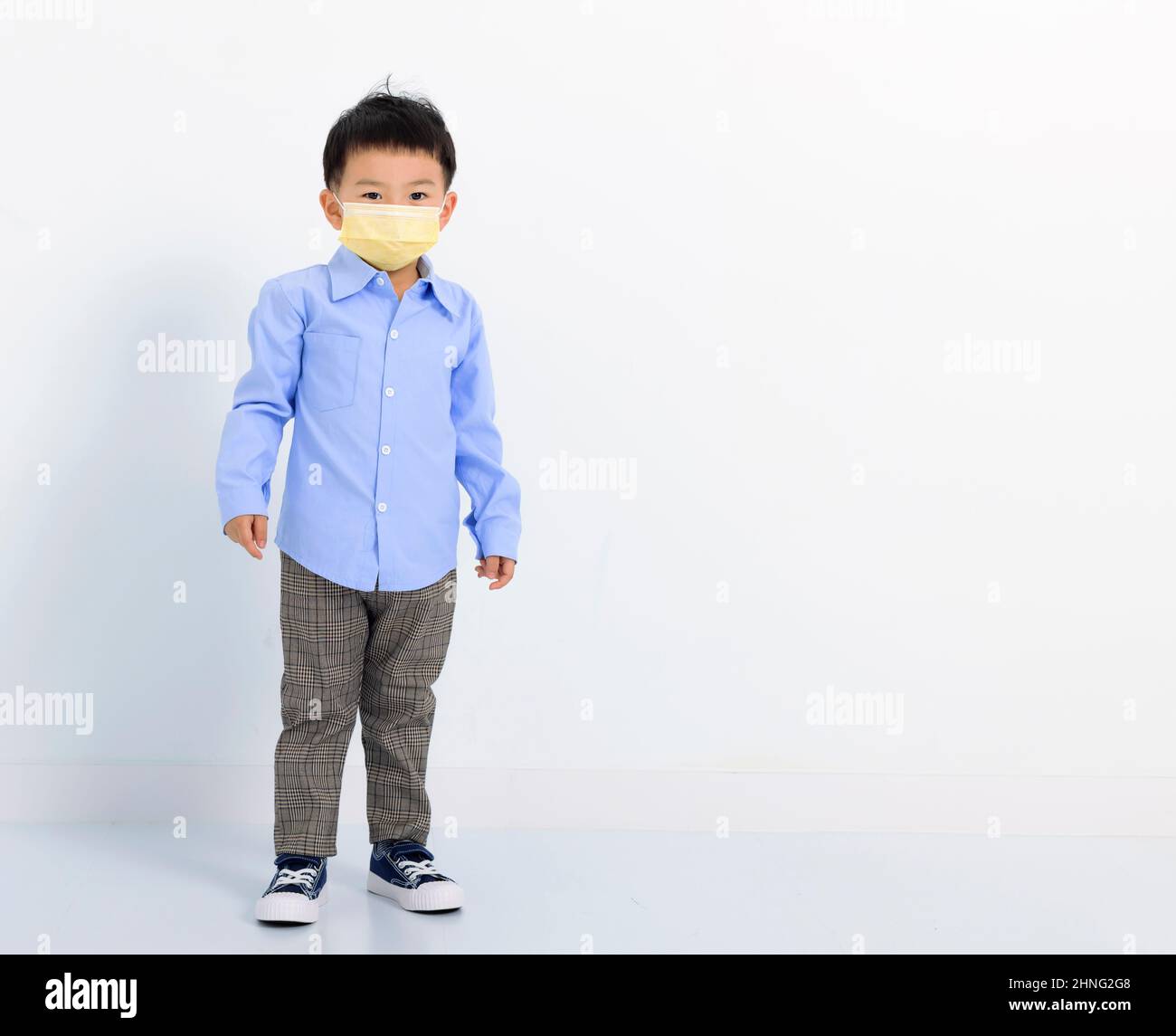 child standing over white background and wearing face mask Stock Photo ...