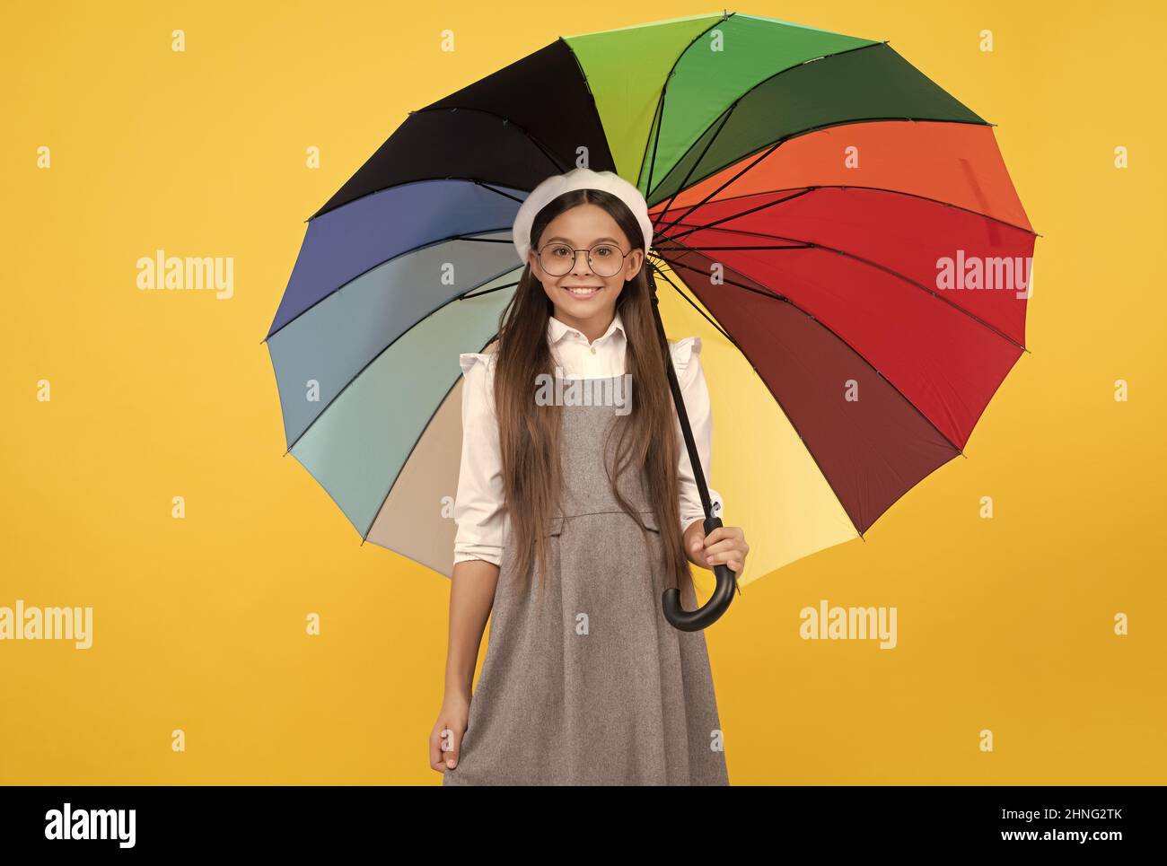 happy teen girl under colorful umbrella for rain protection in autumn ...