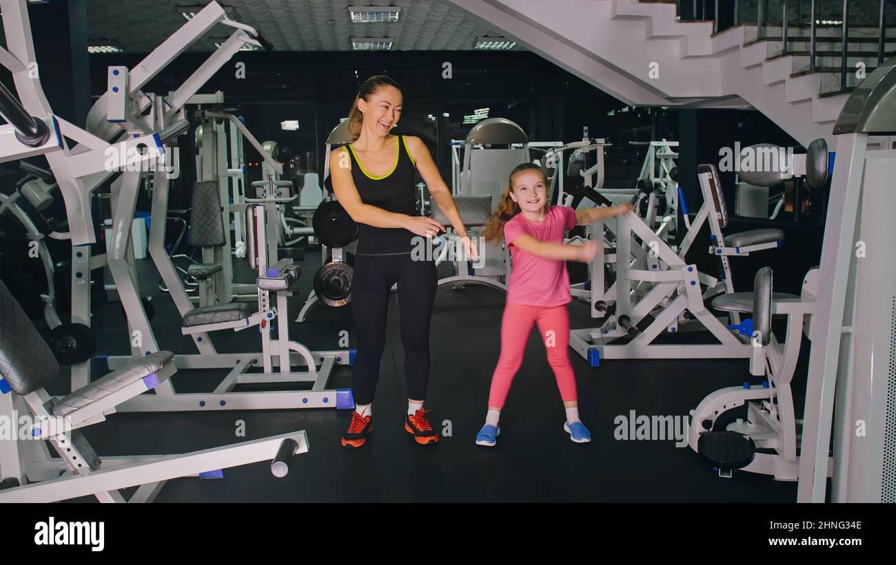 Mother and Daughter in the Gym, Family Performs Physical doing ...