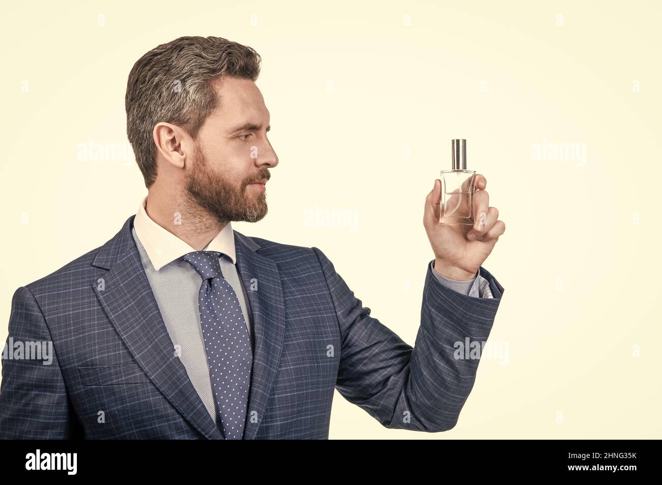 man in businesslike suit presenting product of mens perfume isolated on ...