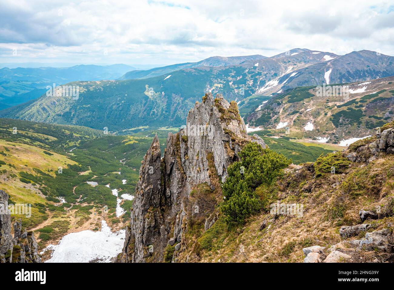 Rock cliff covered with moss against the mountain ranges and sky Stock ...
