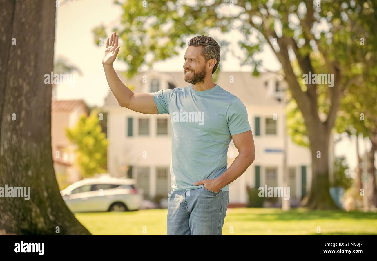 happy unshaven guy welcoming visitors near new house, welcome Stock ...