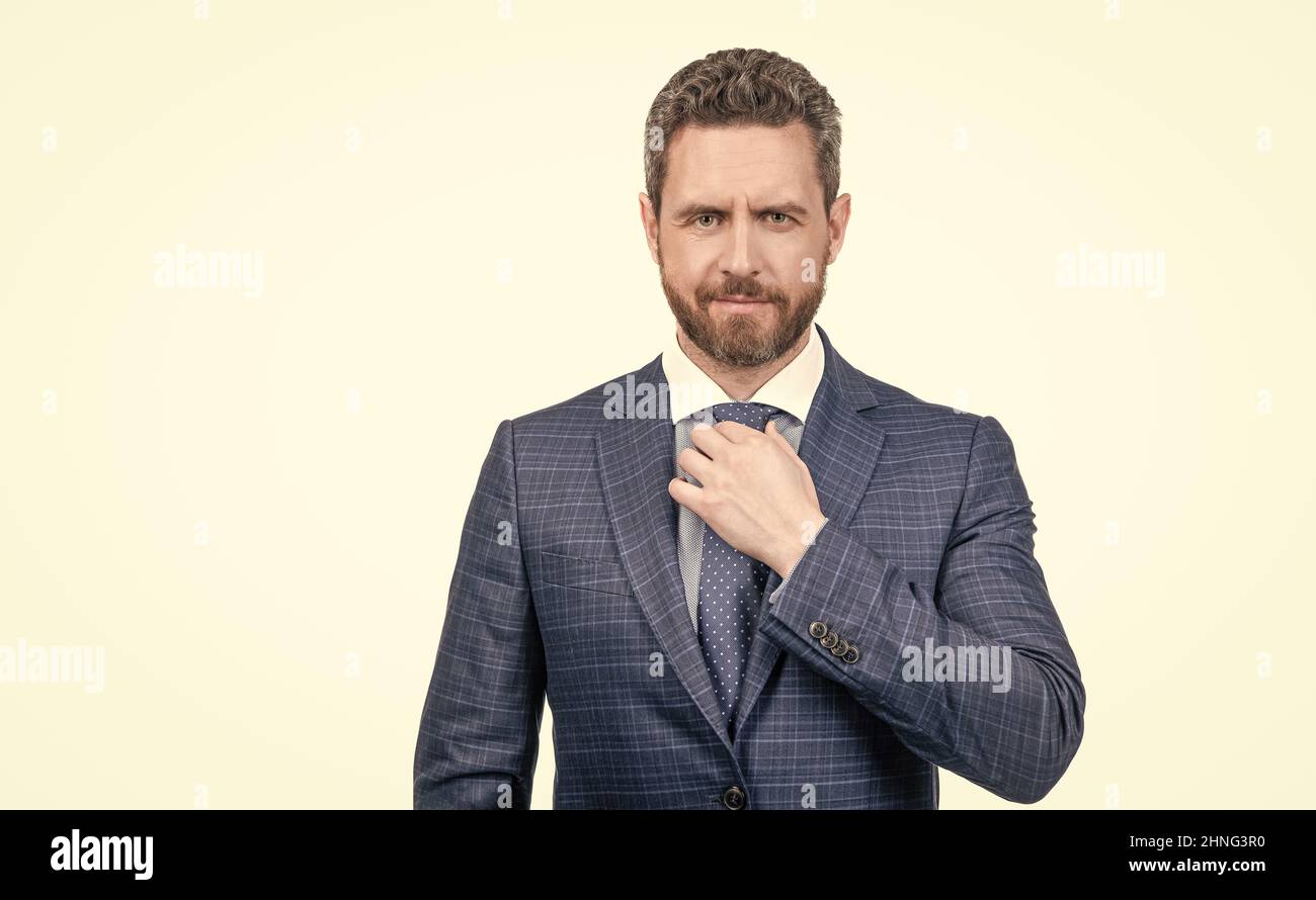 Middle-aged manager fix necktie wearing elegant blue suit in formal ...