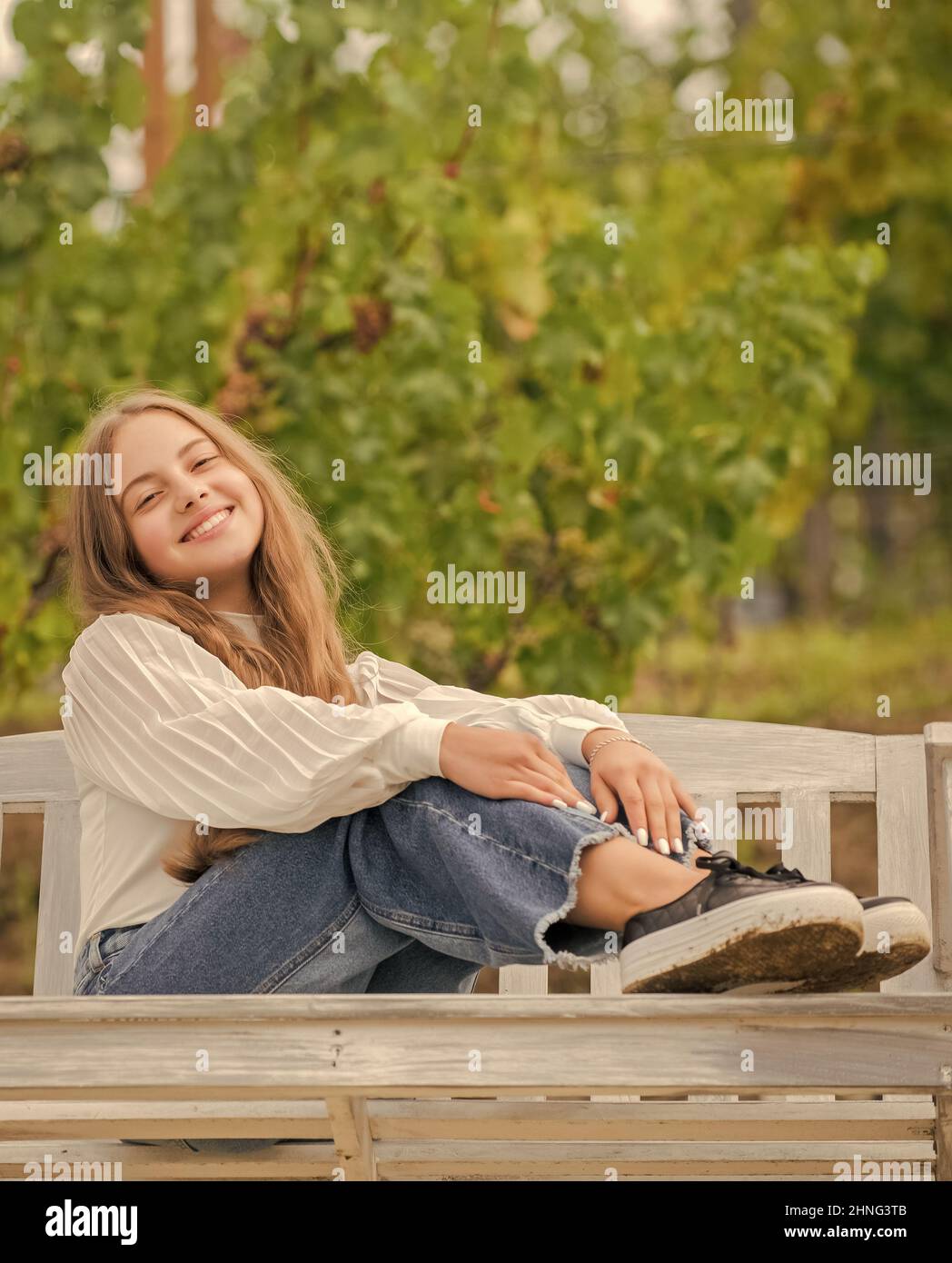 glad child sit on bench outdoor, relaxation Stock Photo - Alamy