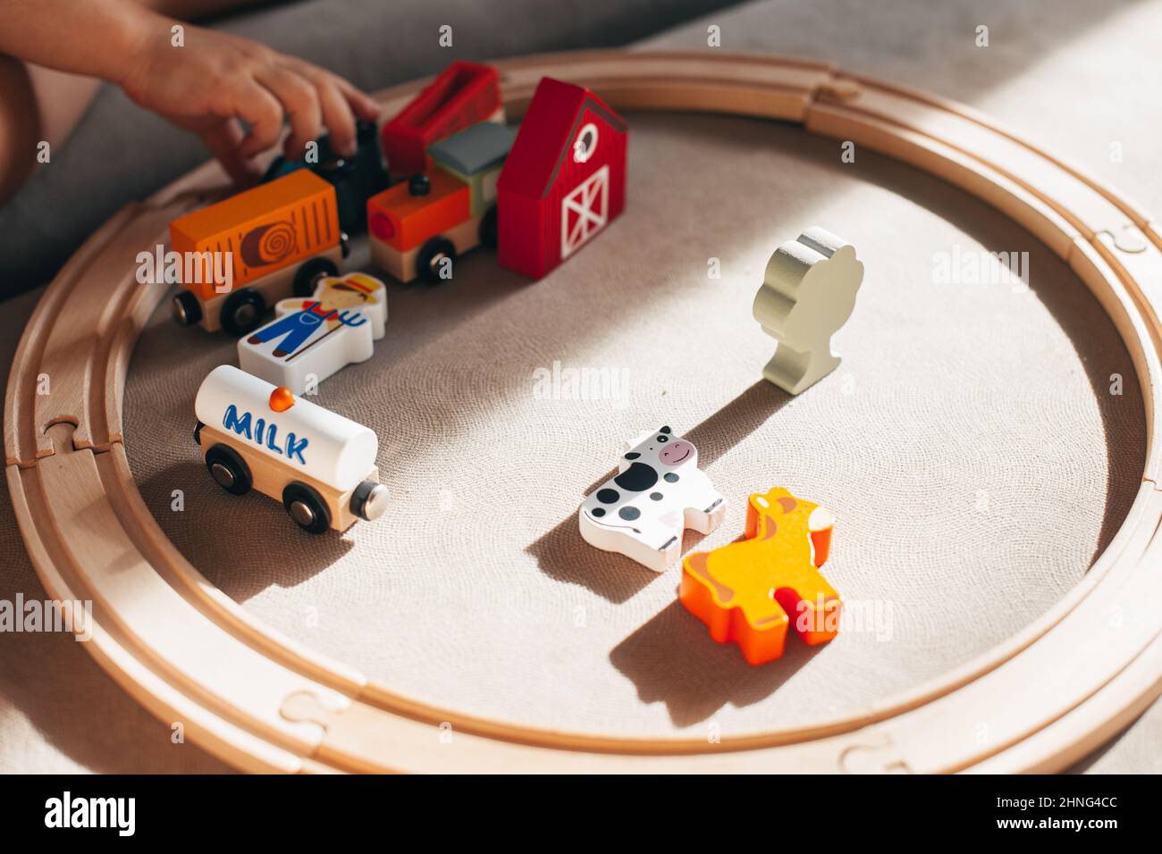 Little boy's hands playing with wooden railroad, toy train rides on ...