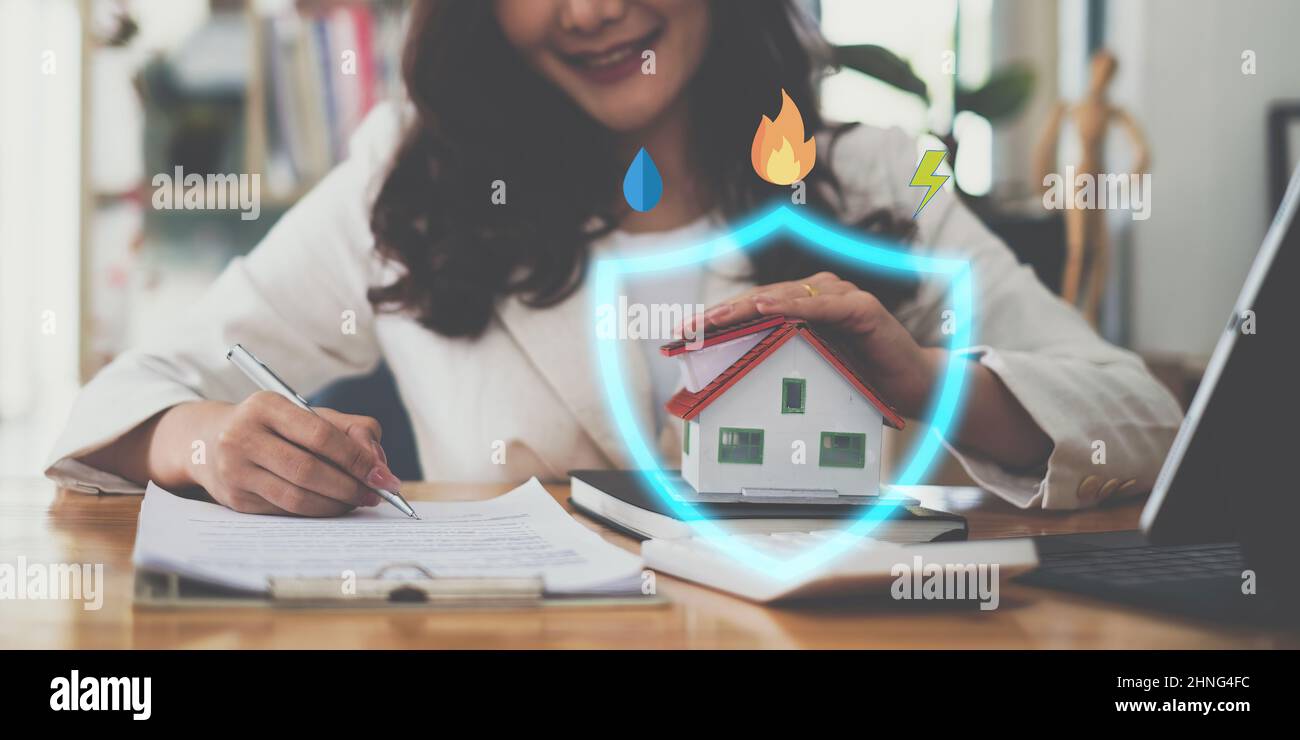 A woman holding and checking house model .Real Estate House Appraisal ...