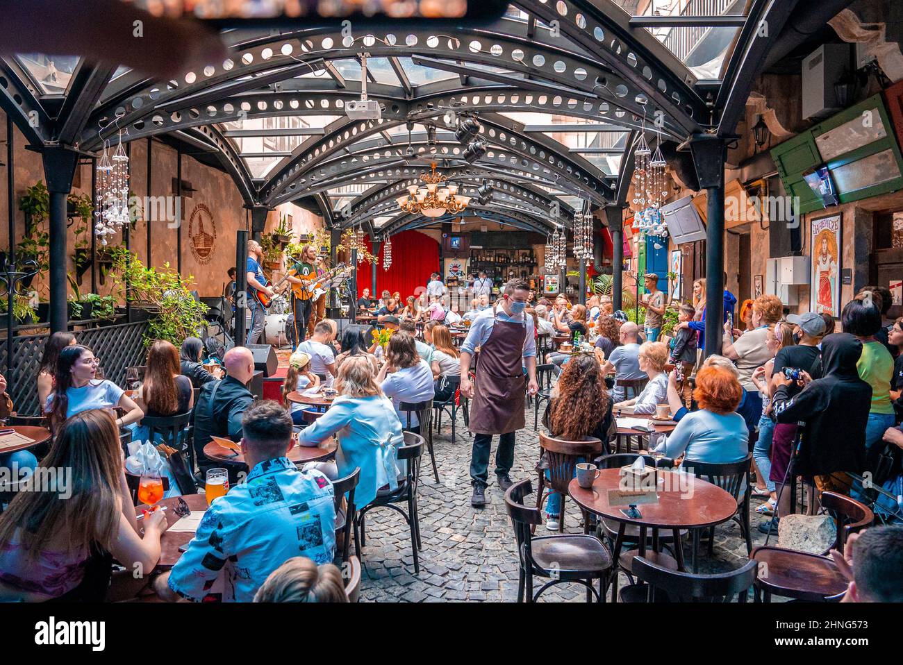 Singers and musicians perfoming and people enjoying at restaurant Stock ...
