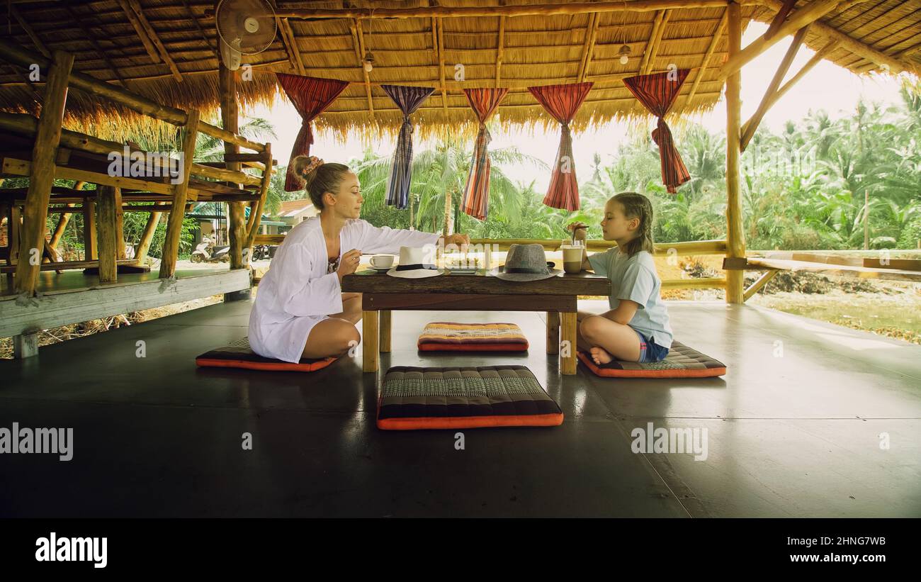 The happy family eat and drink tasty beverages spending time in local ...