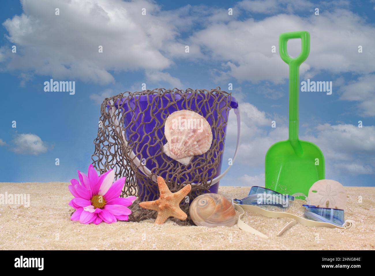 Sand Pail With Net and Sea Shells on Sand With Sky Stock Photo - Alamy