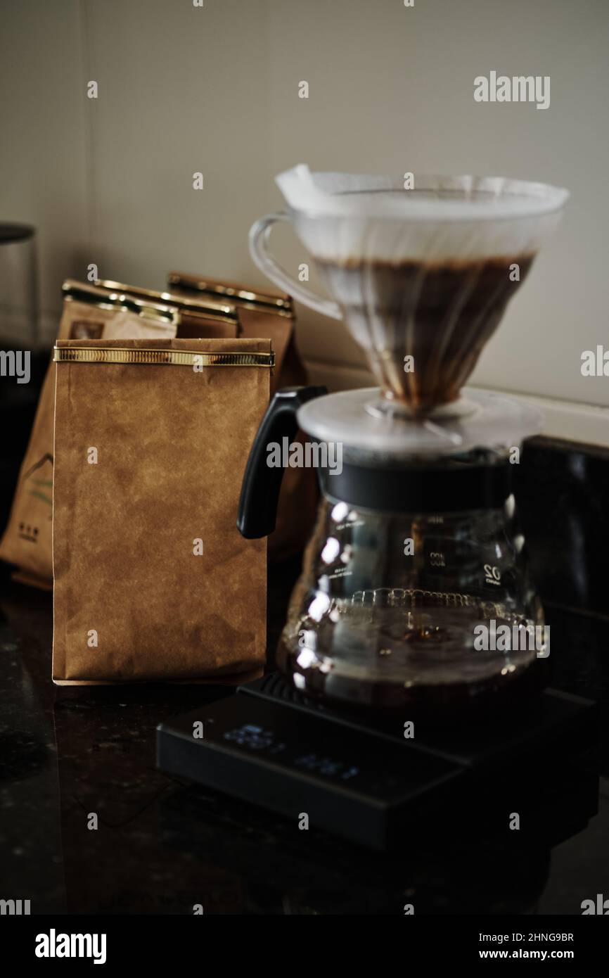Vertical shot of the pour over coffee maker and coffee packets on the ...