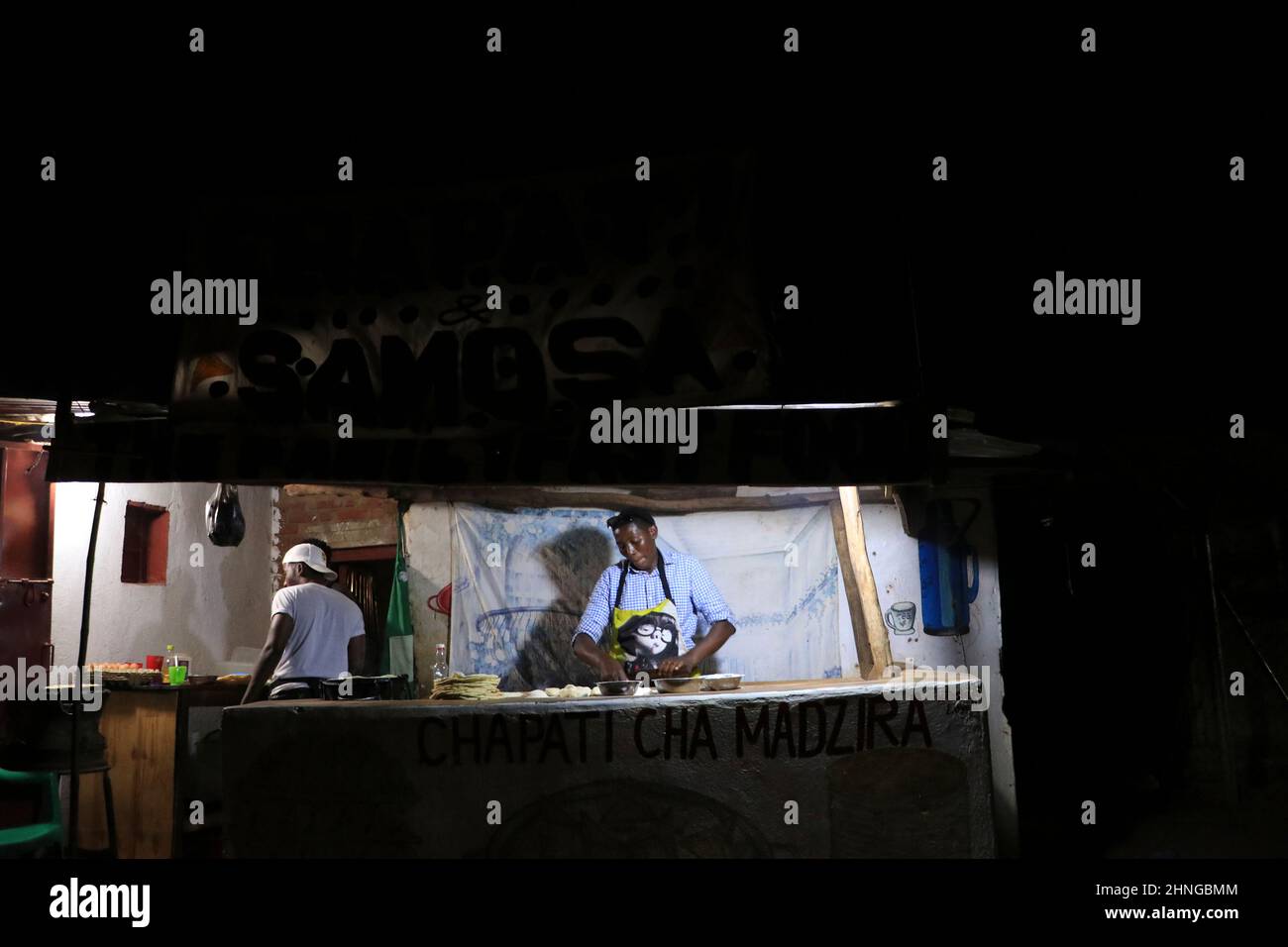 Men are seen preparing food at sunset at Dzaleka Refugee camp, 40 ...