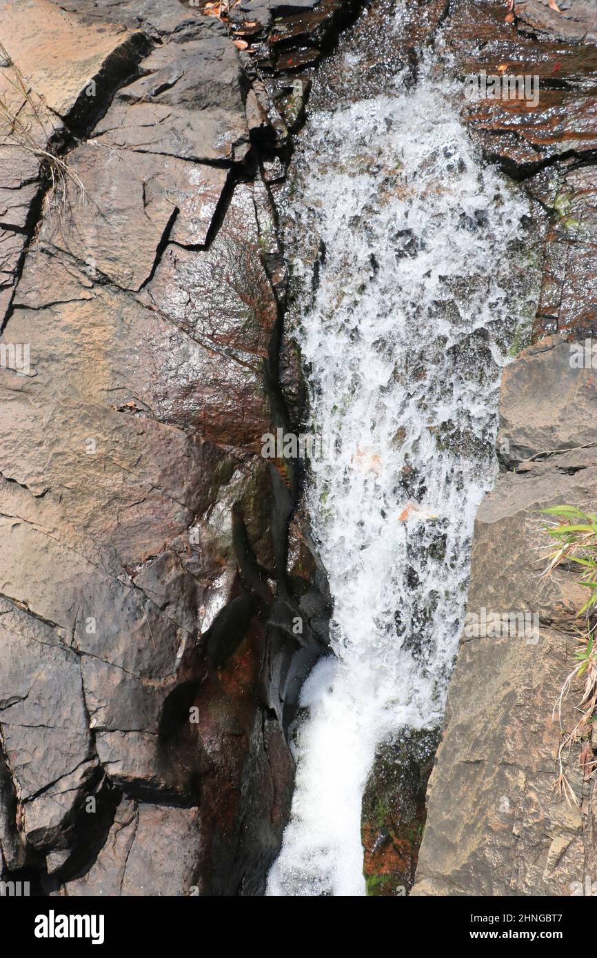 Water is seen flowing in a stream leading to Dzalanyama Waterfall, in ...