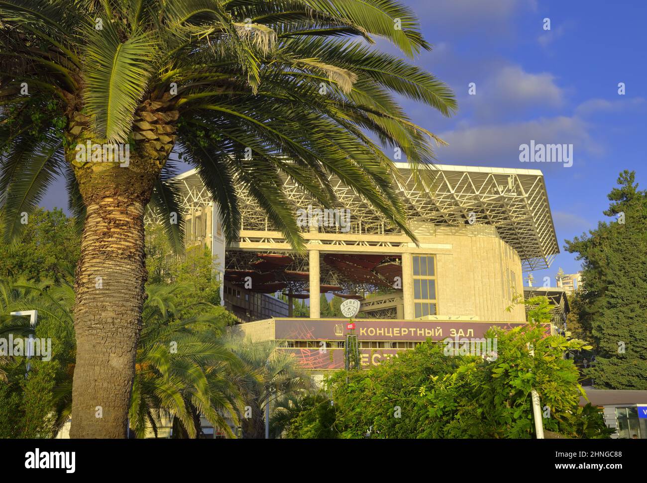Sochi, Russia - 11.01.2021: "Festival Concert Hall" among palm trees. The facade of a building ...