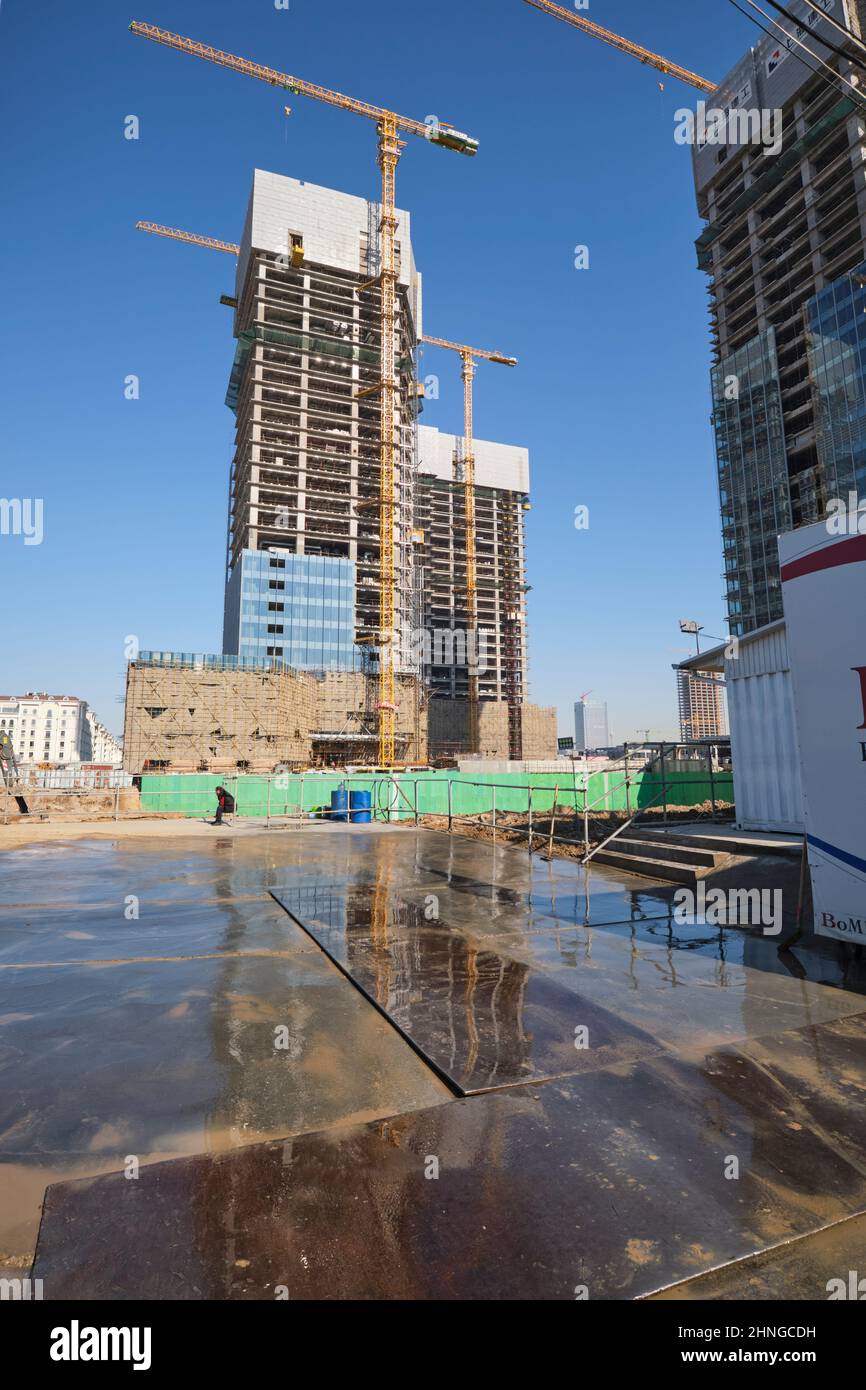 Tall, modern, glass office towers under construciton. At the downtown ...