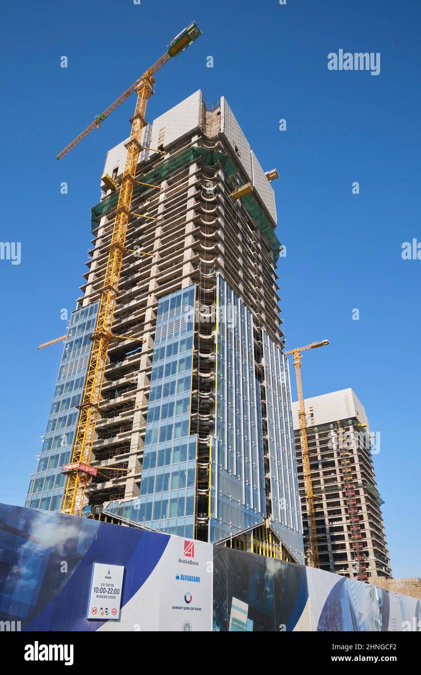 Tall, modern, glass office towers under construciton. At the downtown ...